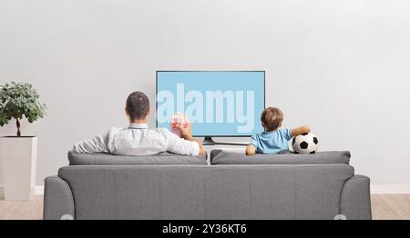 Child watching football game on tv. Little boy in Brazil tricot ...