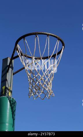 Netball goal ring and net against a blue sky and clouds at Hagley park ...