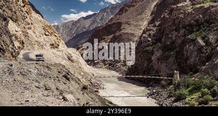 A typical Pakistan bridge is built over a rocky mountain Stock Photo ...