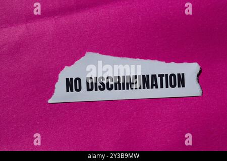 Discrimination. Word written on a piece of paper or note, cork board ...