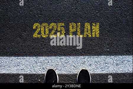 2025 plan message written on ripped torn cardboard paper with orange ...
