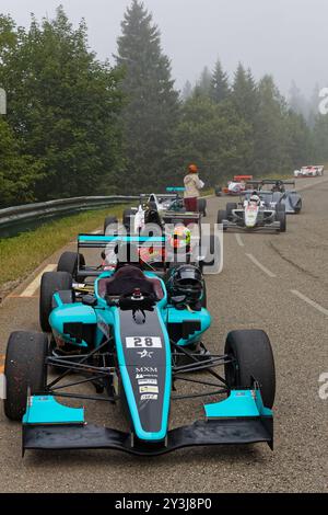 Racing car single seater modern formula in action at turn on wet ...