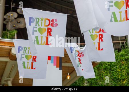A white banner with the words "Pride for All" in colorful rainbow ...