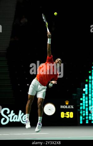 Felix Auger-Aliassime of Canada serves during his round robin singles match against Alexander ...
