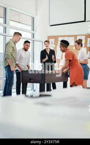 Young employee playing football in the office Stock Photo - Alamy