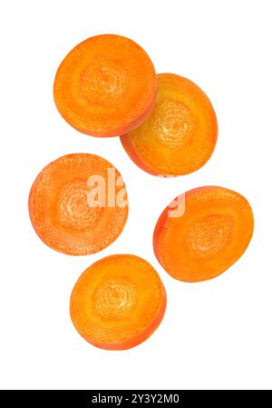 Round carrot slices in air on white background Stock Photo - Alamy