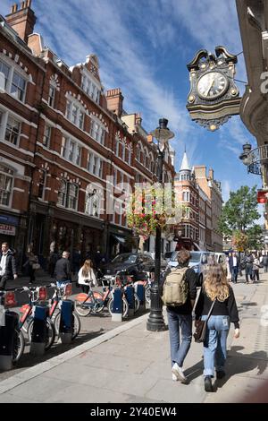 Pedestrians walk along Strand, London, past the Strand Palace Hotel and ...