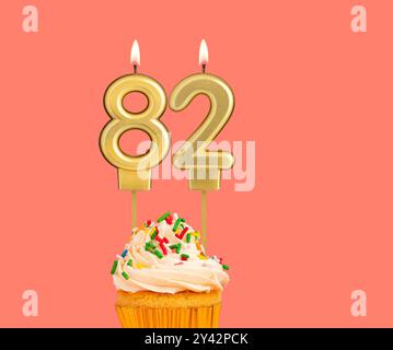 Golden number 82 birthday candle on white background Stock Photo - Alamy