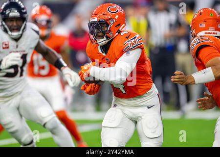 Chicago Bears running back D'Andre Swift (4) jump as he runs away from Minnesota Vikings safety ...