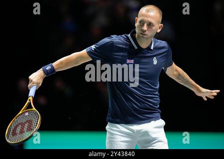 Daniel Evans of Britain plays a shot against Alex De Minaur of ...