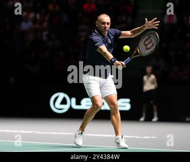 Daniel Evans of Britain plays a shot against Alex De Minaur of ...