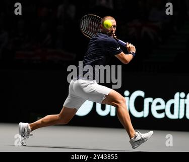 Daniel Evans of Britain plays a shot against Alex De Minaur of ...