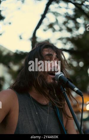Male singer holding microphone standing and performing on stage Stock ...