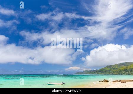 Anse Royale beach under a blue sky with clouds. Mahe island, Seychelles ...