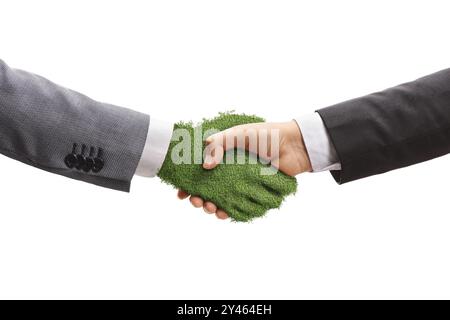 Businessman shaking hand with a green grass hand in front of a ...