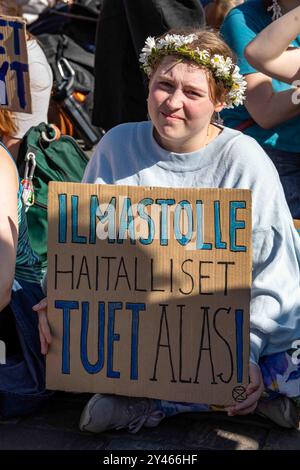 Protester with handwritten cardboard sign at Helsinki Pride 2024 parade ...