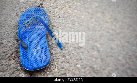 old grungy broken slippers taken low angle Stock Photo - Alamy