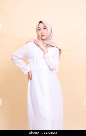 modern asian female with hand cream on beige background Stock Photo - Alamy