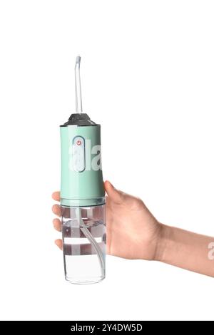 Female hand holding oral irrigator on white background Stock Photo - Alamy