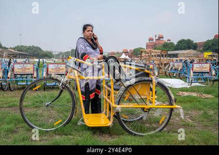 A woman seen with a new handicapped manual tricycle, which she received ...