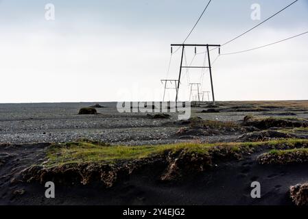power lines with symmetrical wooden pylons stand out over desolate ...