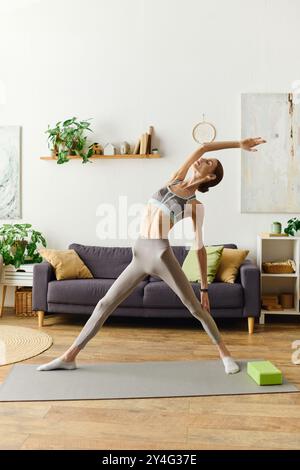 A young woman with anorexia practices her workout routine at home, focusing on her health ...