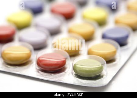 Colourful tablets packed in plastic, tablet addiction, drug addiction ...