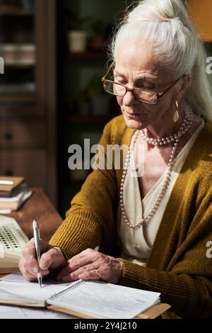 Woman focusing on work while sitting on bench using laptop in a natural ...