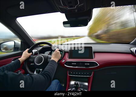 Woman driving a car fast Stock Photo - Alamy
