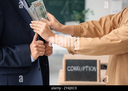 Male teacher taking bribe in classroom, closeup. Corruption concept ...