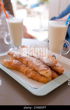 Fartons, typical pastries from Valencia, Spain, with hot chocolate, in ...