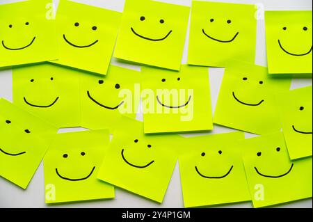 Colored sheets of paper, with smiley faces drawn on them, inclusion ...