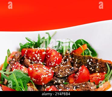 Straccetti salad with grilled beef, arugula and tomatoes close-up on ...