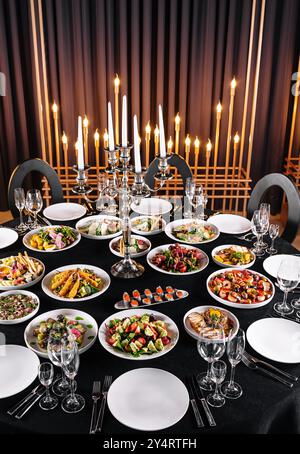 Luxurious dinner table setup with a candelabra and gourmet dishes Stock ...