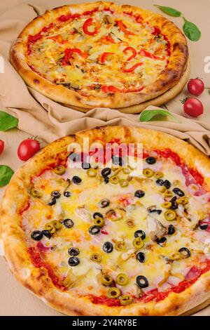 Two delicious pizzas with savory toppings on a beige background Stock ...
