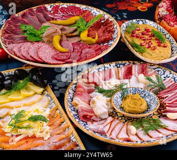 Fish and meat snacks on a festive table with spices and sauces. Meat ...
