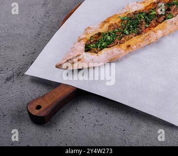 Turkish stuffed flatbread pide on gray wooden table Stock Photo - Alamy
