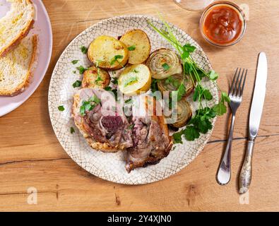 Side dish of baked lamb leg with potatoes and pepper Stock Photo - Alamy