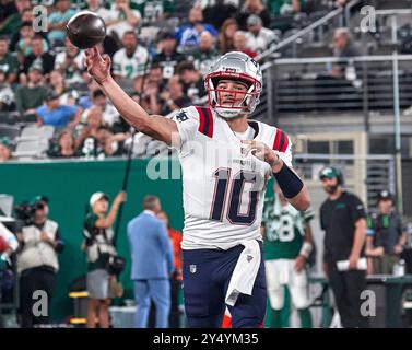 New England Patriots quarterback Drake Maye (10) warms up before an NFL football game against ...