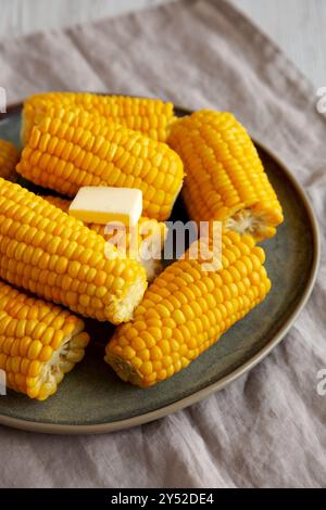 Homemade Steamed Corn on the Cob with Butter on a Plate, side view ...