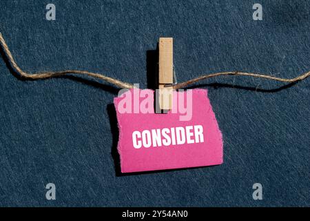 Consider message written on pink paper with blue background. Conceptual ...