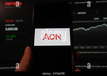 In this photo illustration, the logo of Aon is seen displayed on the ...