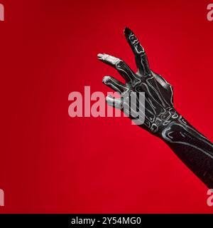 Creepy skeleton hand gesturing against red background. Perfect for ...