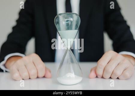 Businessman in time management concept Stock Photo - Alamy