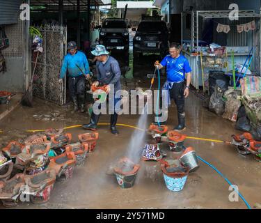 September 17, 2024, Chiang Rai, Thailand: A woman is seen sitting under ...
