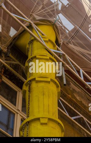 Construction site with barrier and waste container or skip for building ...