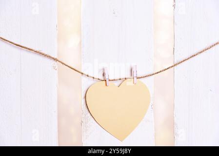 Yellow paper clips with heart on blue background Stock Photo - Alamy