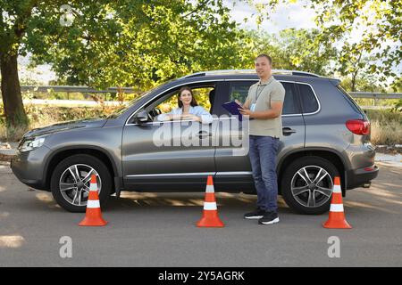Woman passing maneuverability driving test on track Stock Photo - Alamy