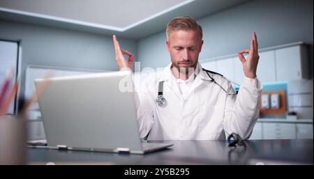 Medical Doctor Meditation In Office. Yoga At Workplace Stock Photo - Alamy