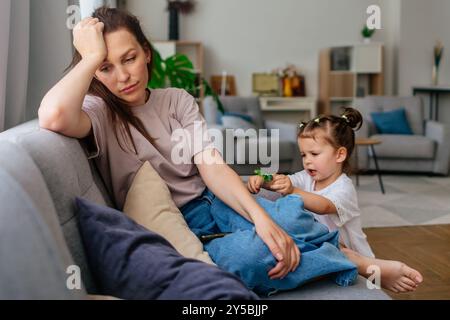 Tired single mother suffering from postpartum depression. Exhausted ...
